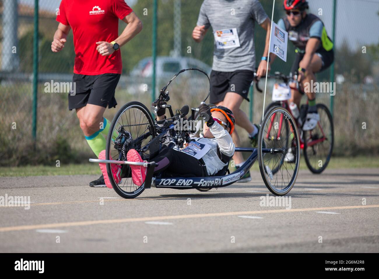 Disabled Athlete who Trains with her Hand Bike with Cyclist and Runners ...