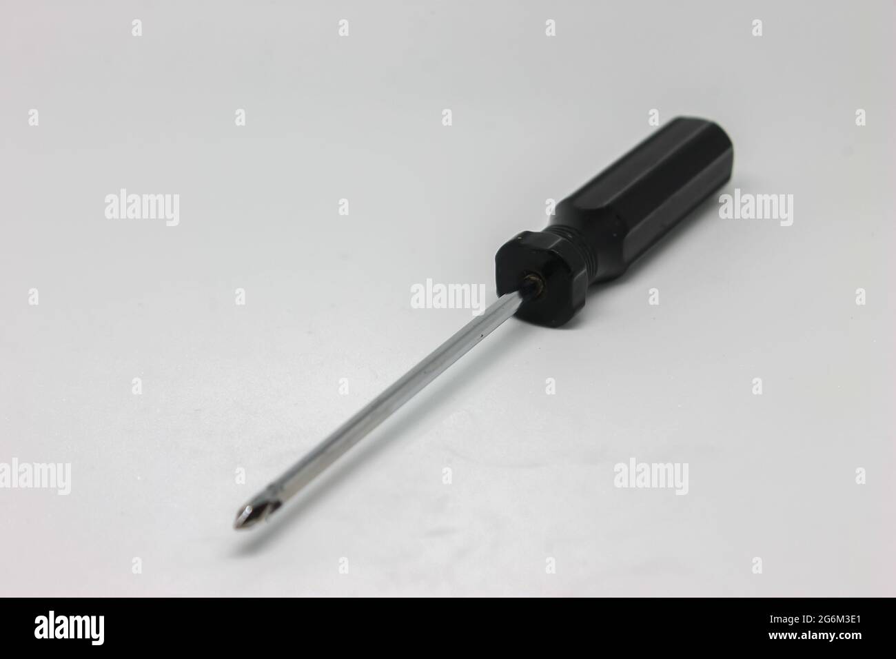 Screwdriver plus black color on a white background Stock Photo - Alamy