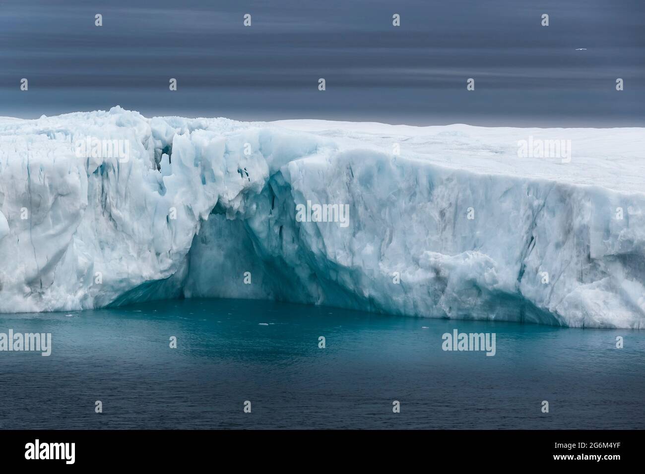 A large iceberg with crevices floating in the arctic ocean. Svalbard ... A large iceberg with crevices floating in the arctic ocean. Svalbard ...
