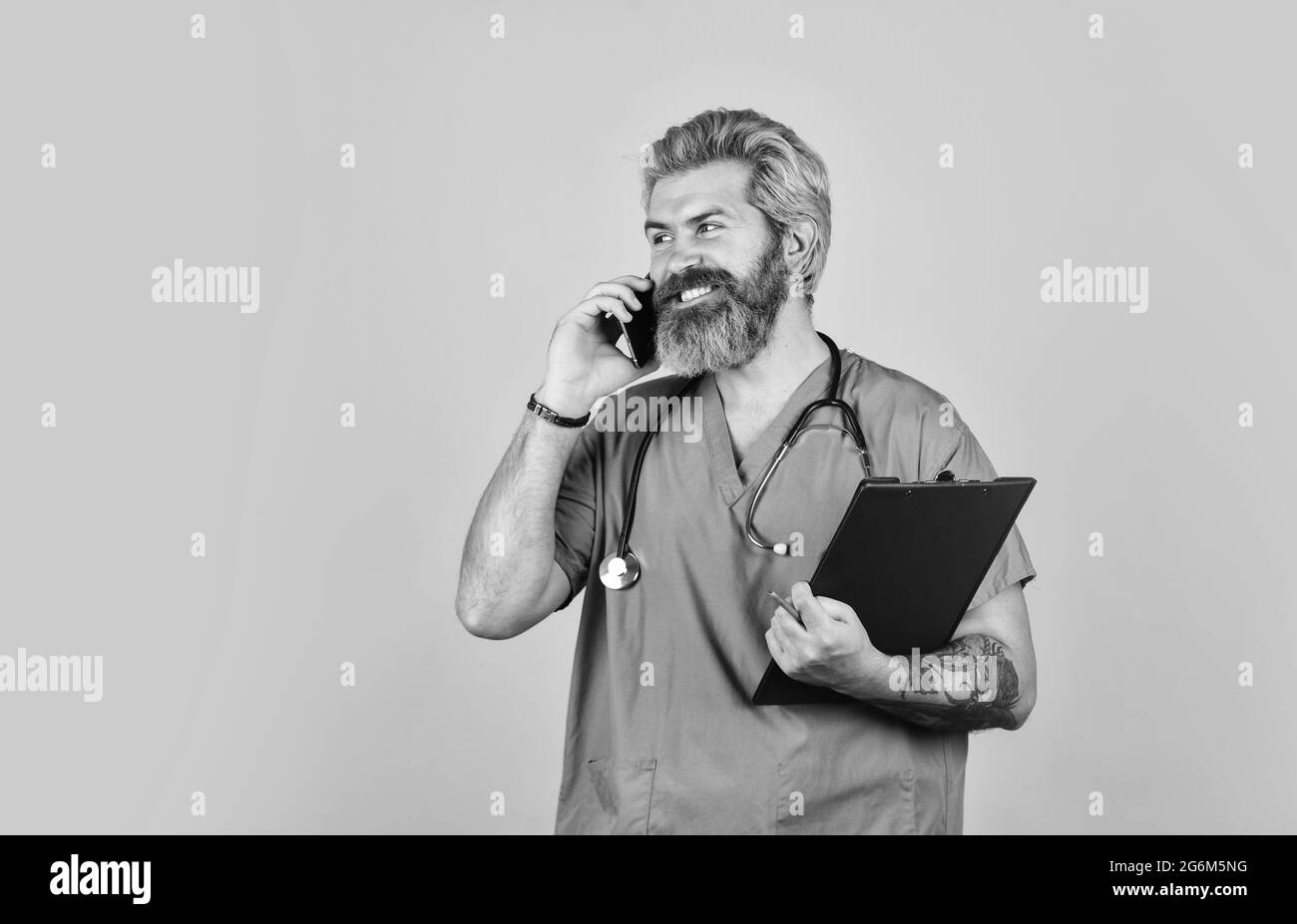 Doctor checking notes Black and White Stock Photos & Images - Alamy