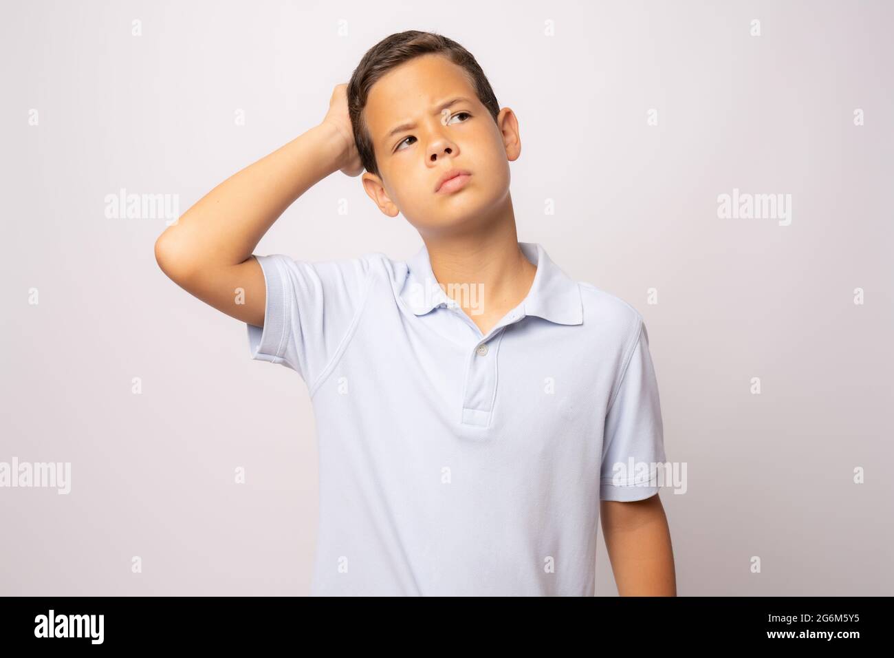Beautiful child thinking and looking upward. Portrait of child on white ...