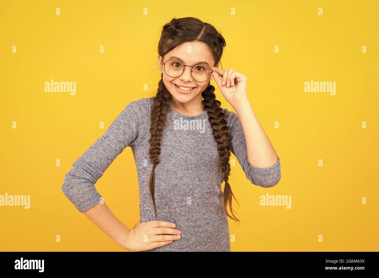 Glasses she likes the look of. Happy girl with intellectual look ...