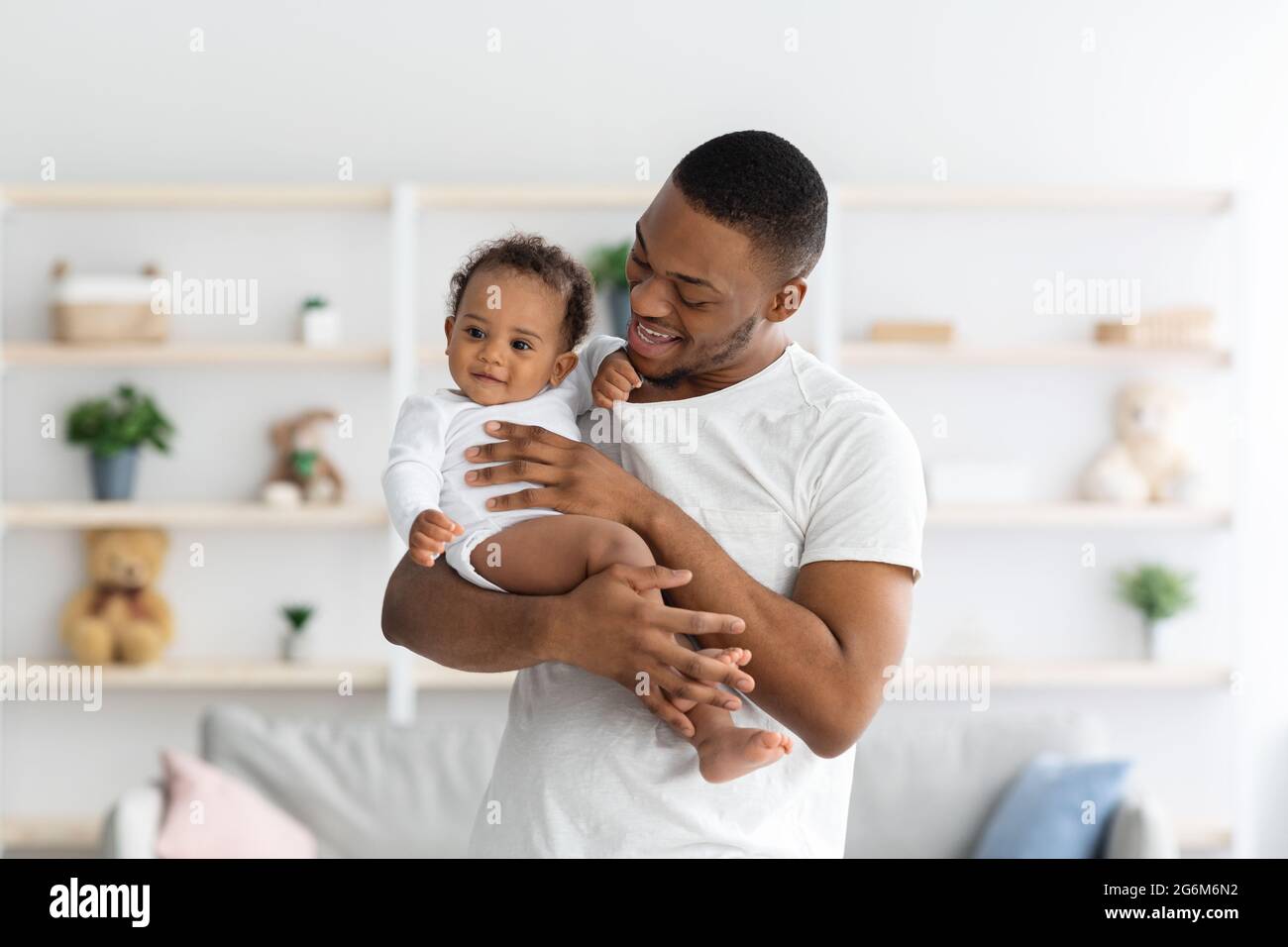 Young Black Dad Holding His Adorable Newborn Baby, Tenderly Embracing ...
