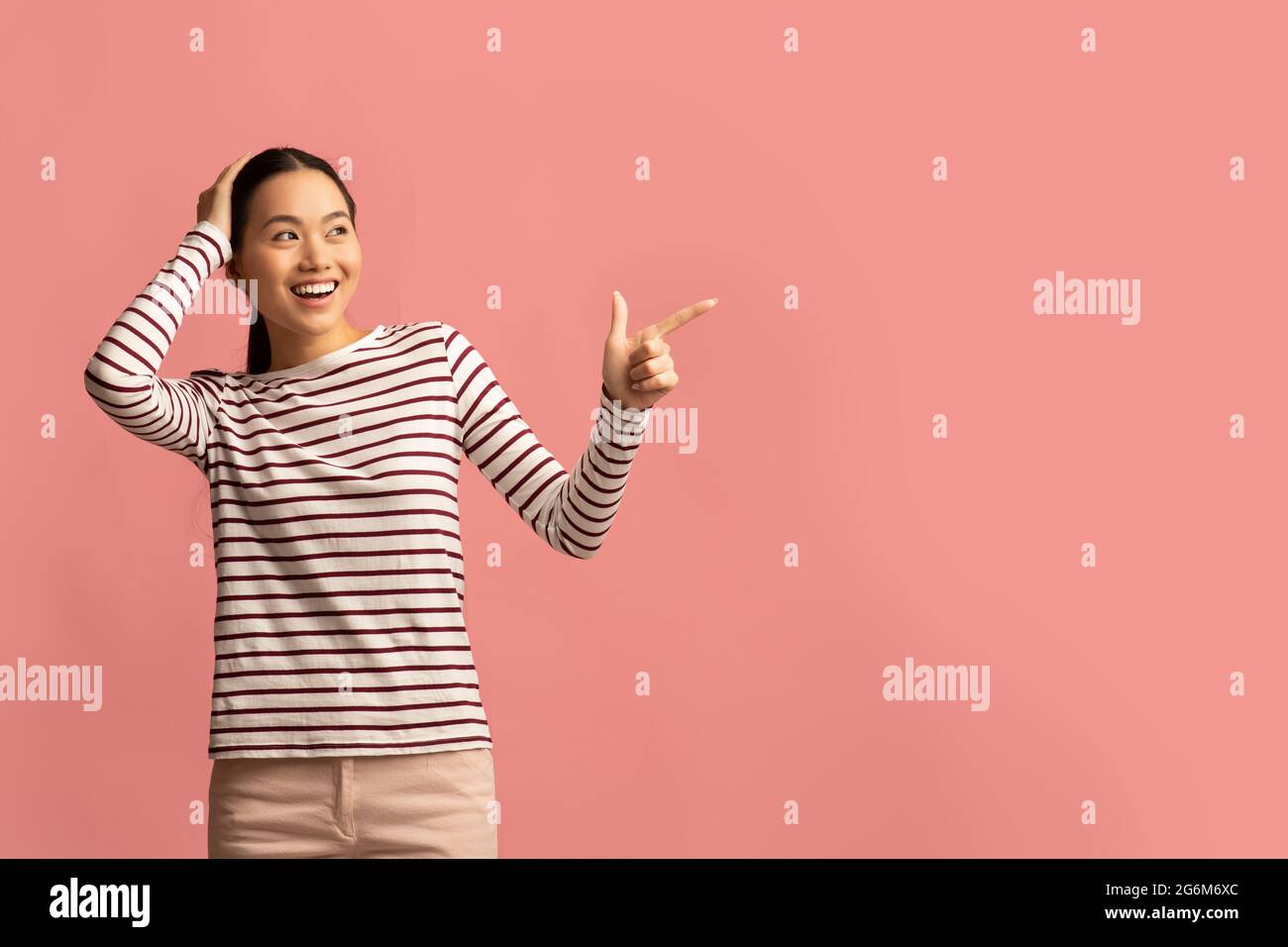 Joyful Young Korean Woman Pointing Aside At Copy Space With Finger ...