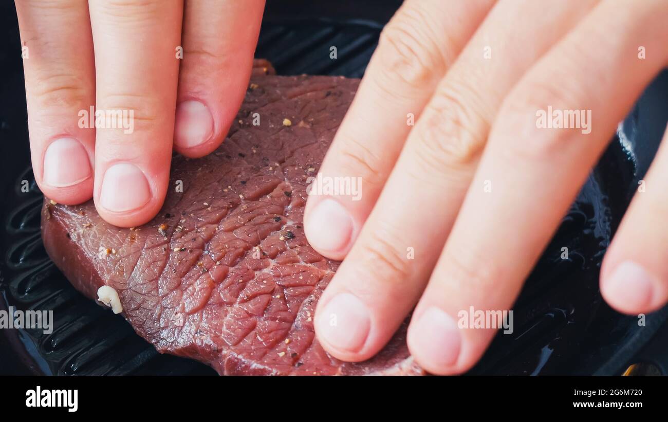 Cropped view of chef putting spiced beef steak on grill pan Stock Photo ...
