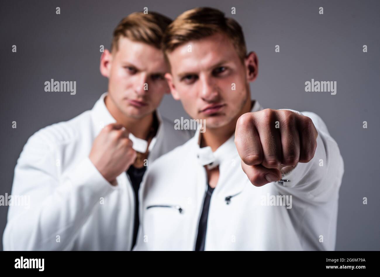 two cousin show fist. young confident brothers. confident fashion ...