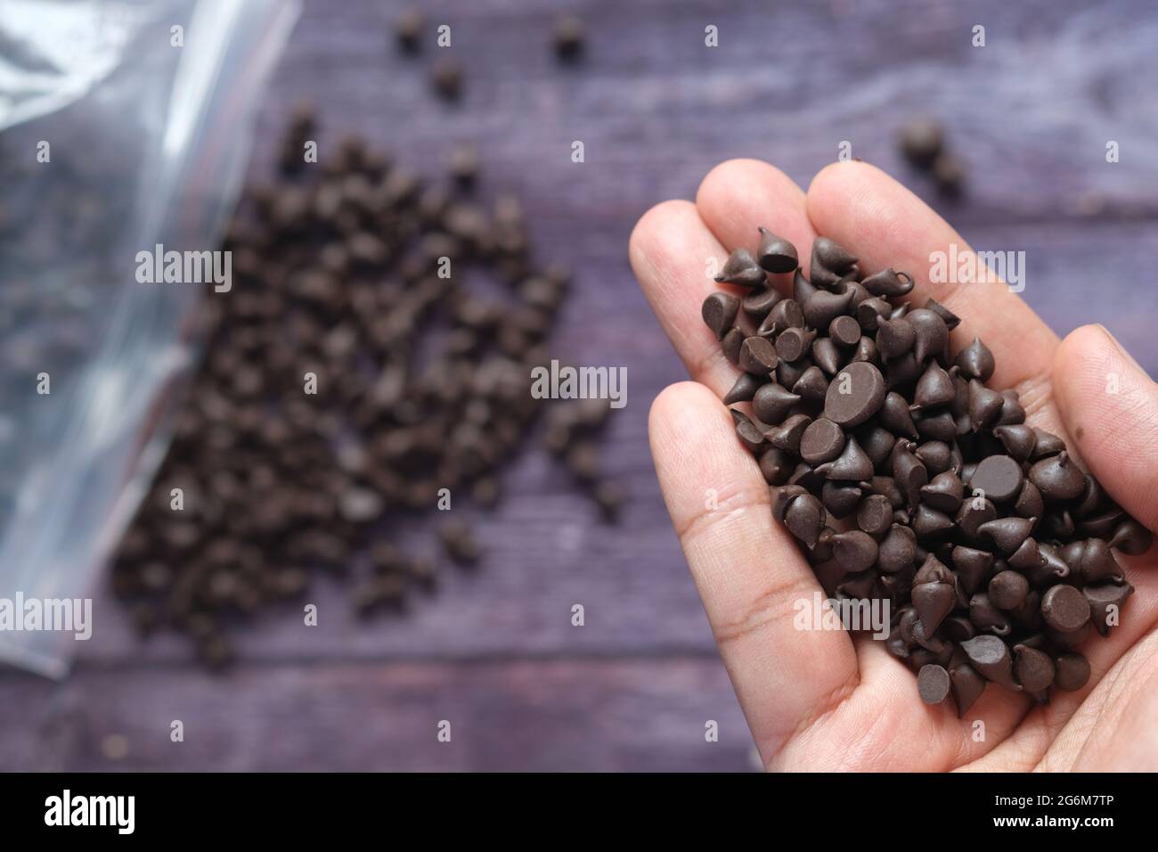 Chocolate chips on palm of hand top view Stock Photo - Alamy