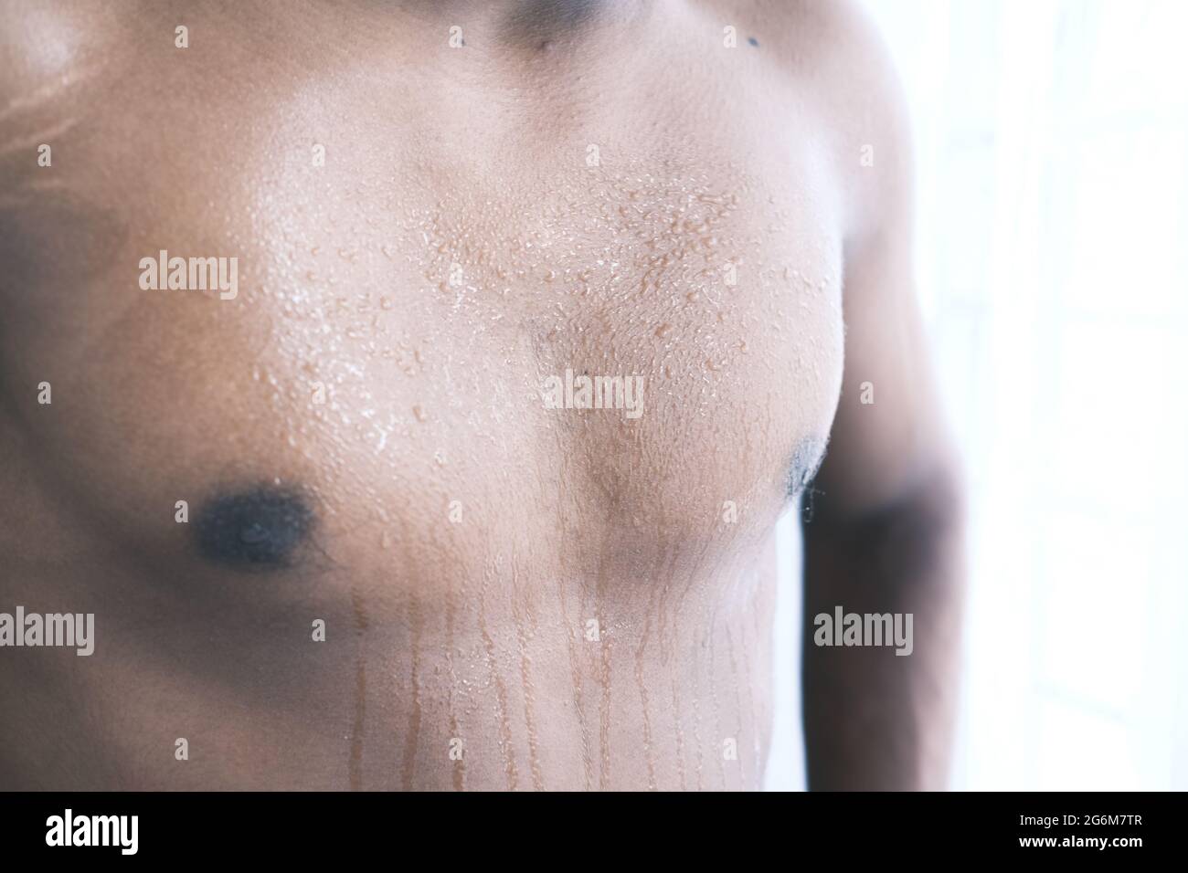 young man skin sweating in chests Stock Photo - Alamy