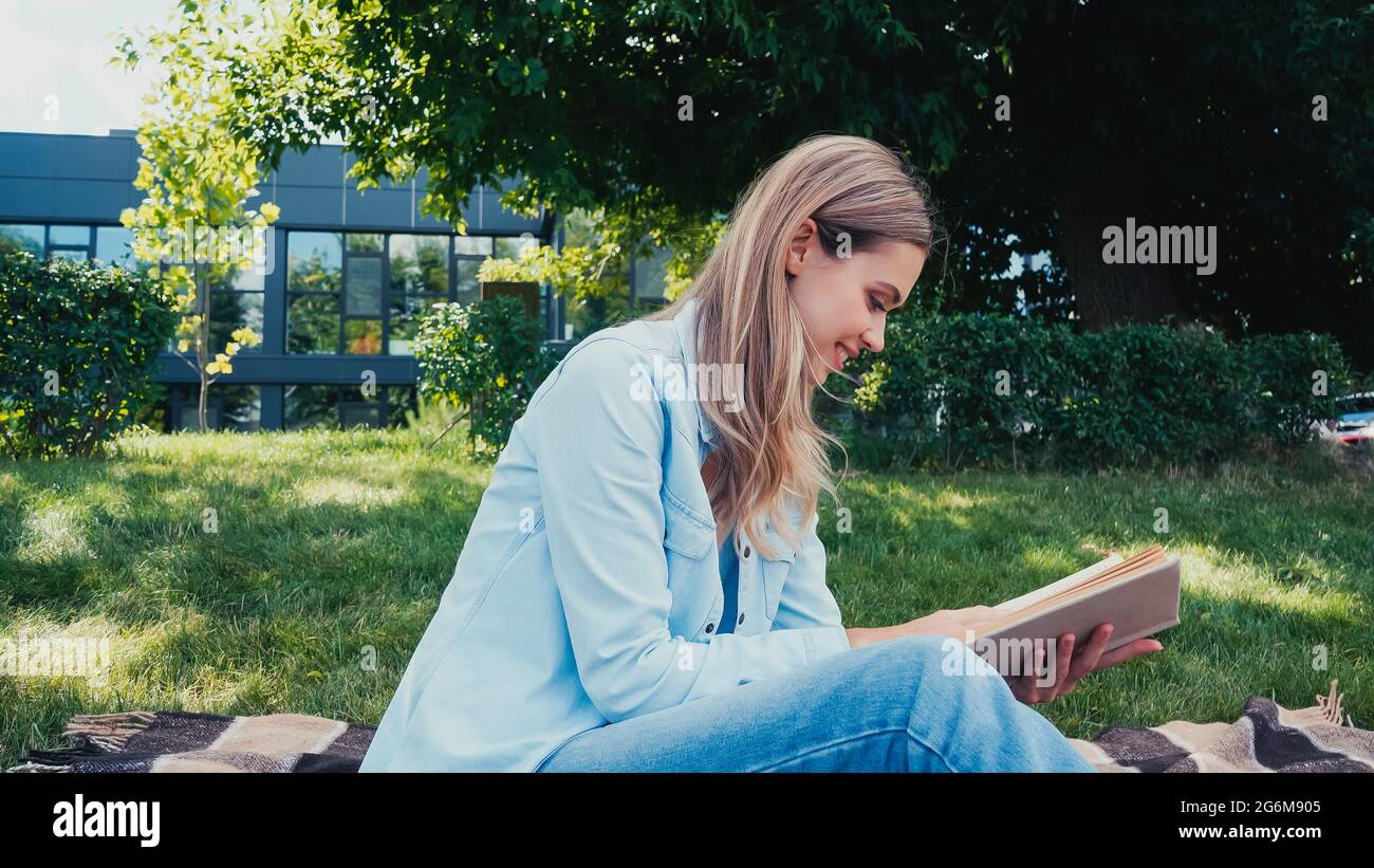 Happy young woman book outdoors hi-res stock photography and images - Alamy