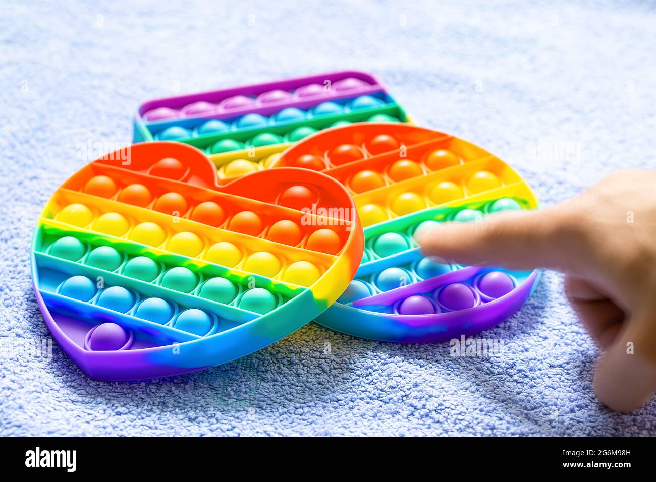 Trending kids toys antistress pop it with index finger over bubbles for ...