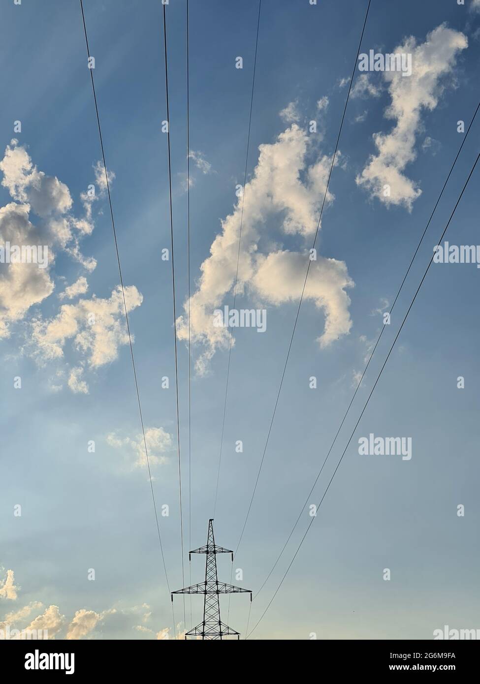 Electric wires from power lines on background of blue sky with clouds ...