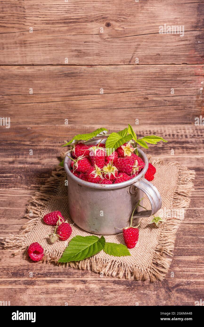 Raspberries background. Ripe fruits in a vintage mug, rustic style ...