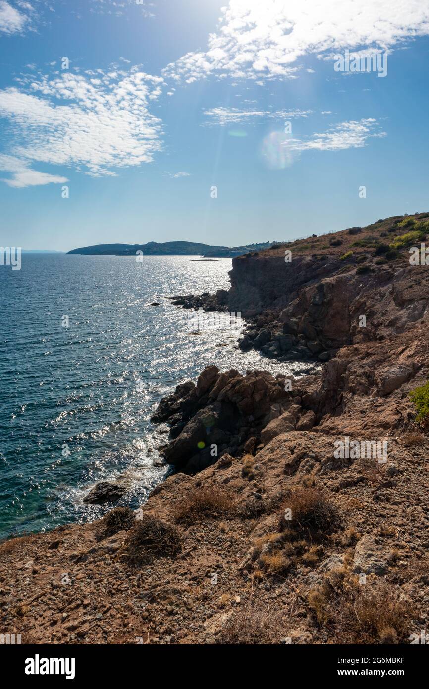 Rocky, with dry bushes, wild cliffs, sea shore line landscape near ...