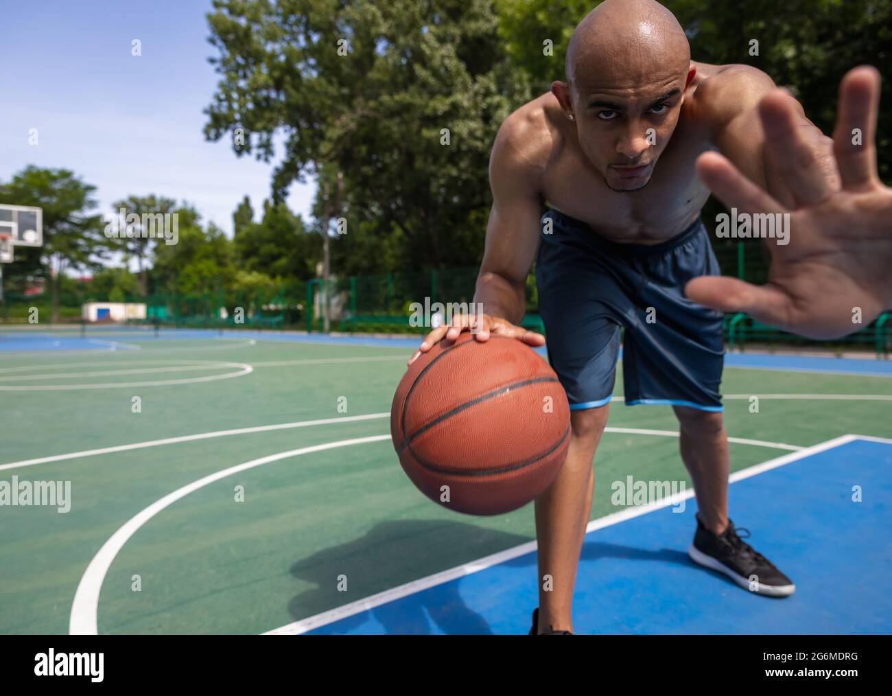 Stop, defense. Young man, muscular african male basketball player ...