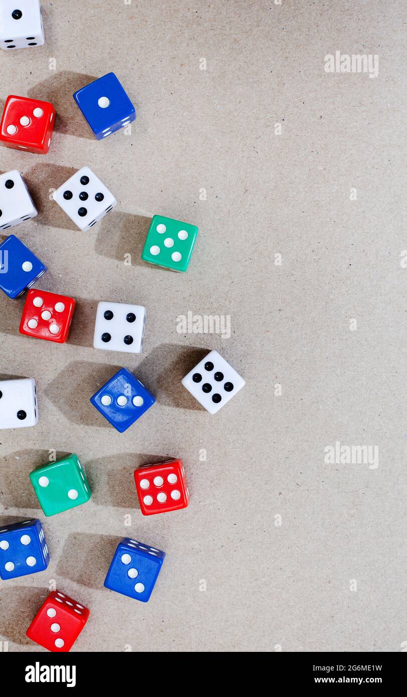 mix of colored playing dice on neutral background Stock Photo - Alamy