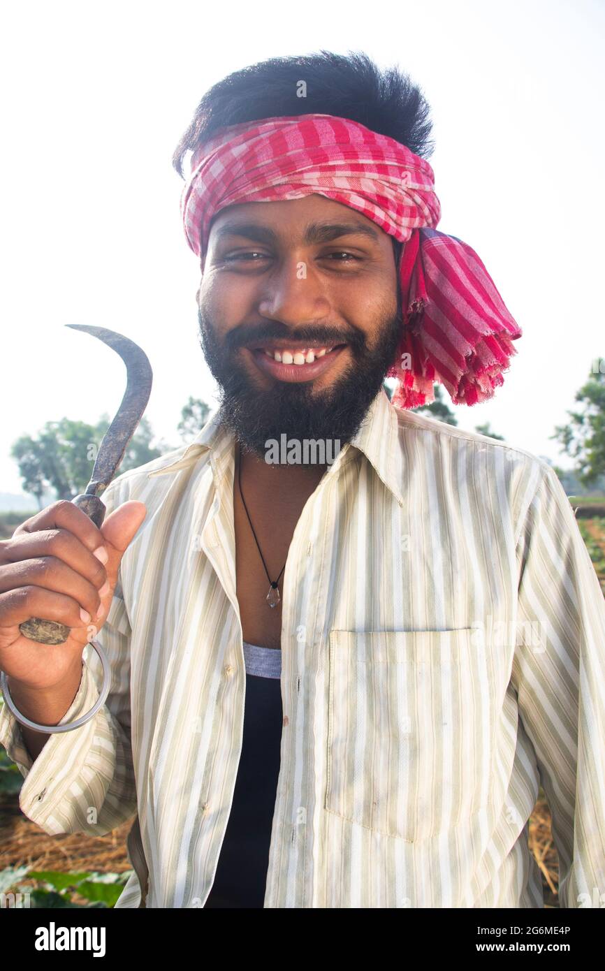 Rural Indian Farmer Holding Sickle in agricultural field Stock Photo ...