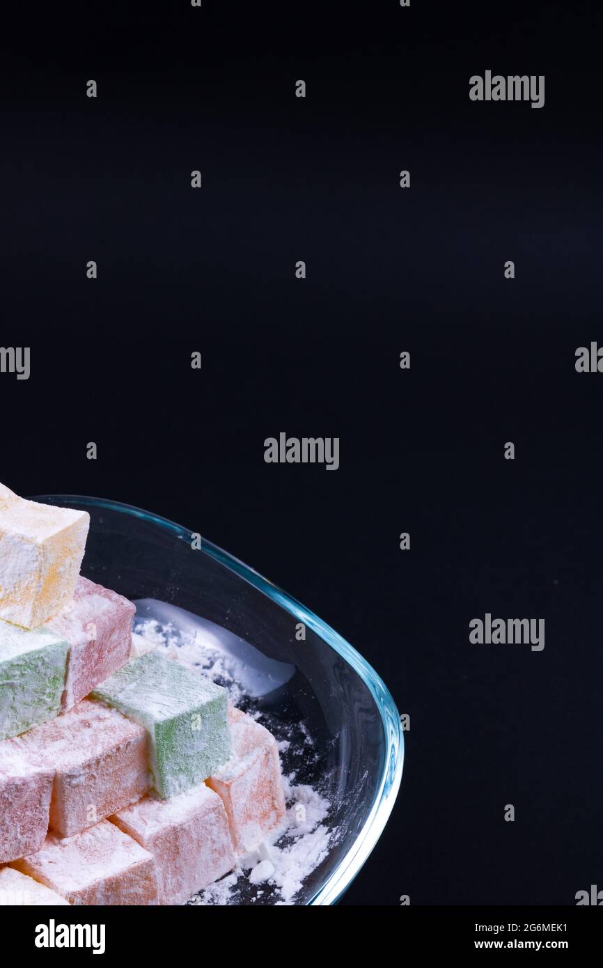 Turkish Delights in a glass bowl isolated on black background Stock ...
