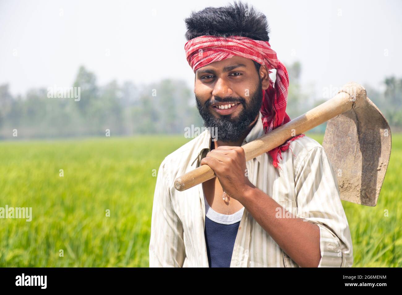Portrait of a Farmer holding a spade on his shoulder Standing on his ...