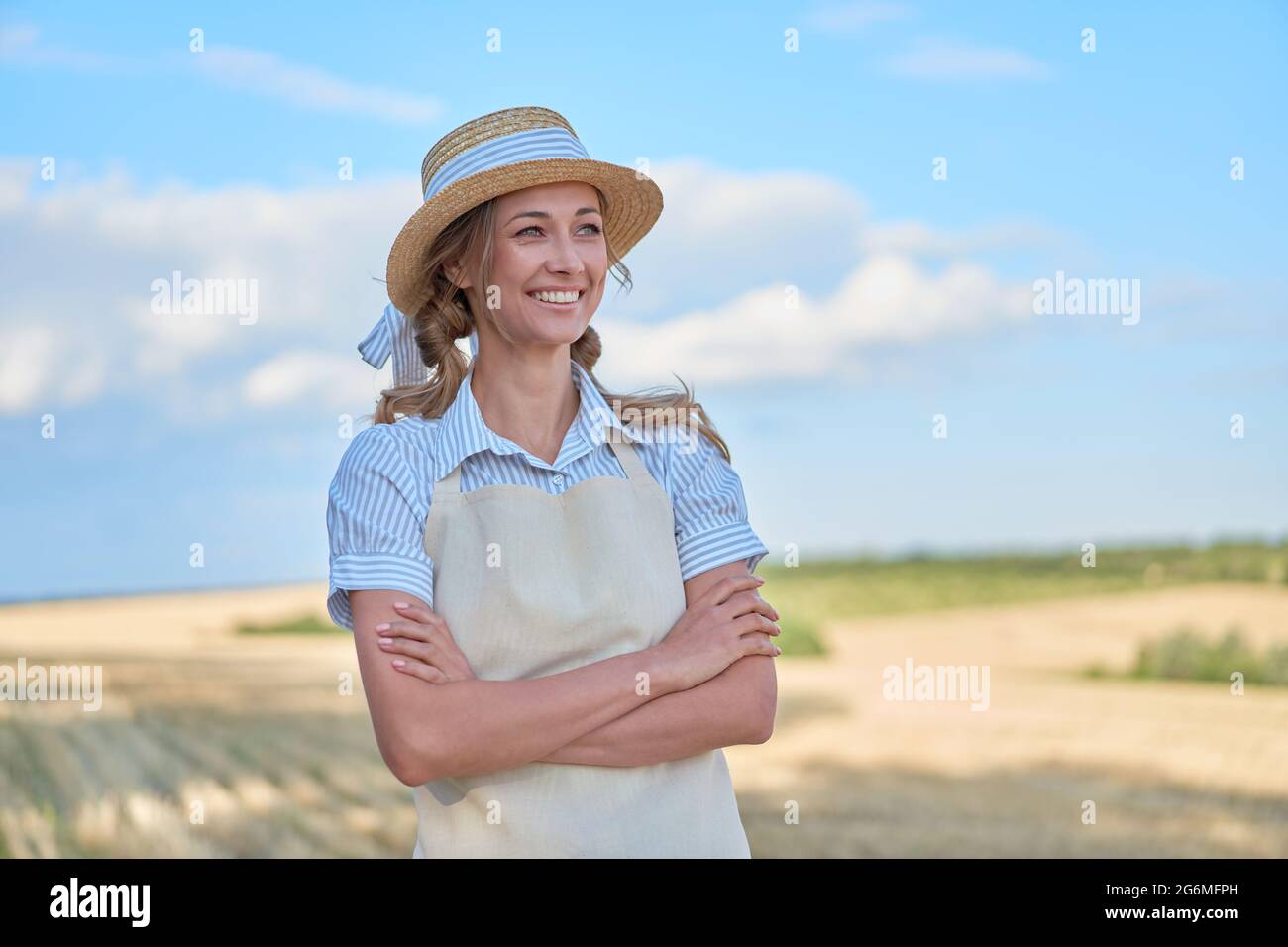 Woman farmer straw hat apron standing farmland smiling showing thumb up ...