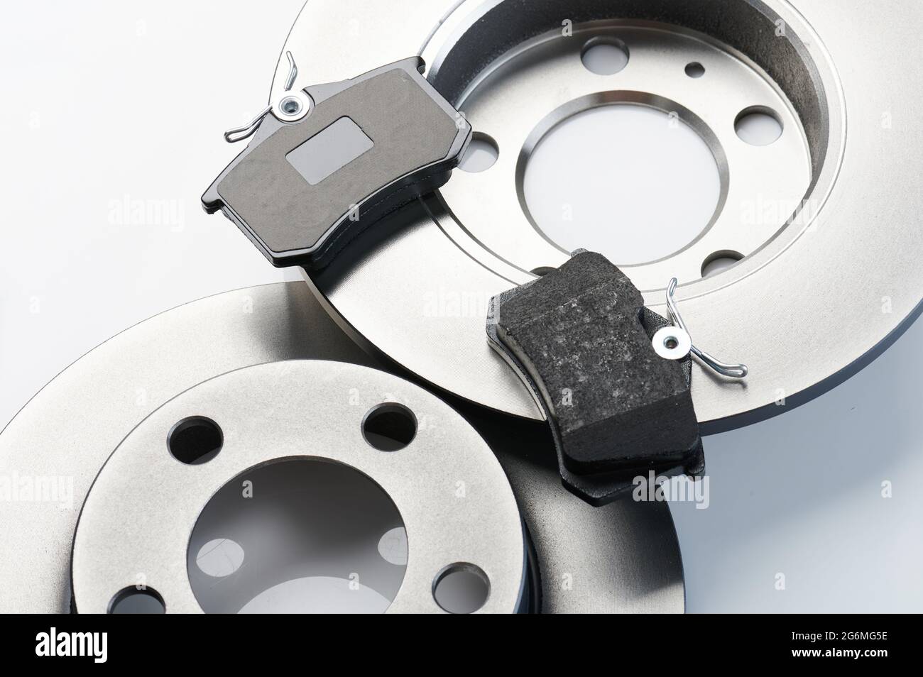 Shiny break metal disc and pads isolated on studio background. Car stop ...
