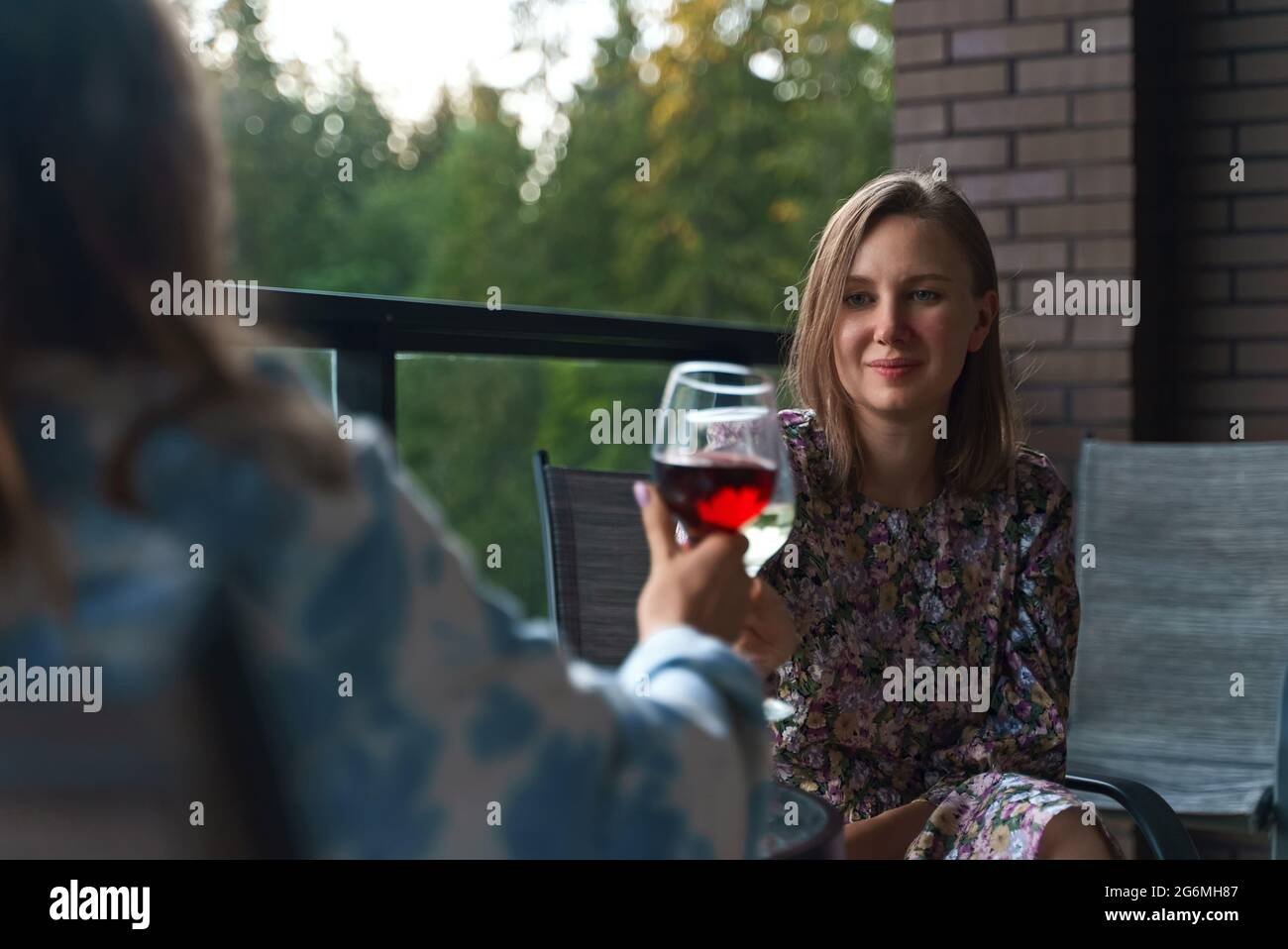 Two people talking on balcony hi-res stock photography and images - Alamy