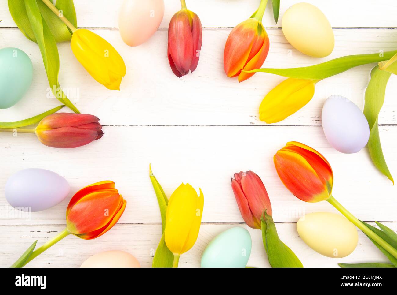 Easter Themed Frame Background on a White Wooden Table Stock Photo - Alamy
