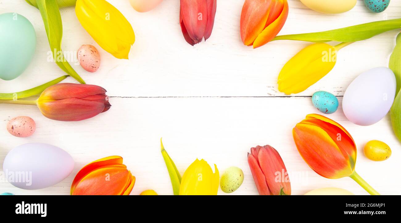Easter Themed Frame Background on a White Wooden Table Stock Photo - Alamy