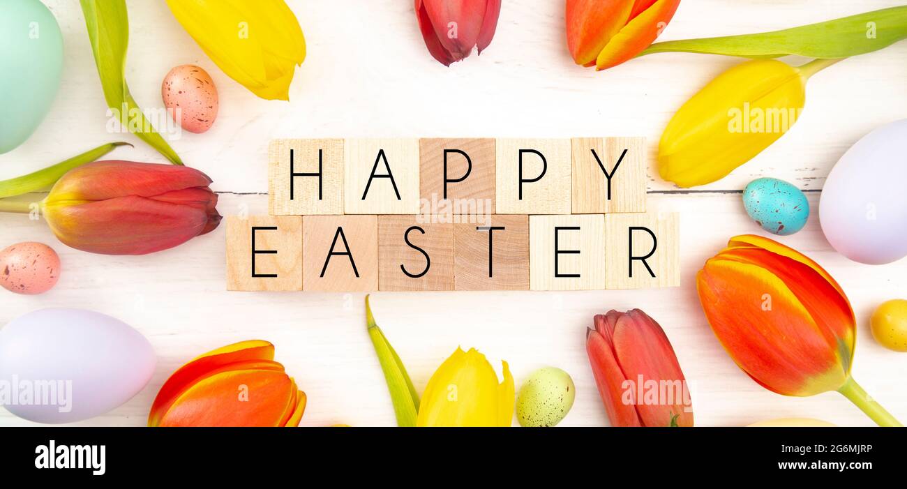 Happy Easter Spelled in a Frame of Eggs and Tulips Stock Photo - Alamy