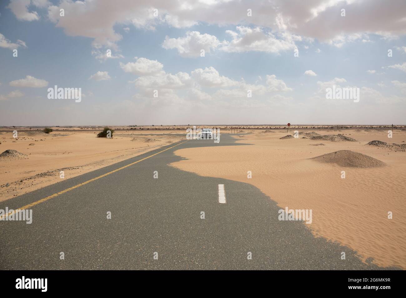 Driving around the desert in a Nissan sunny, Dubai, UAE Stock Photo - Alamy