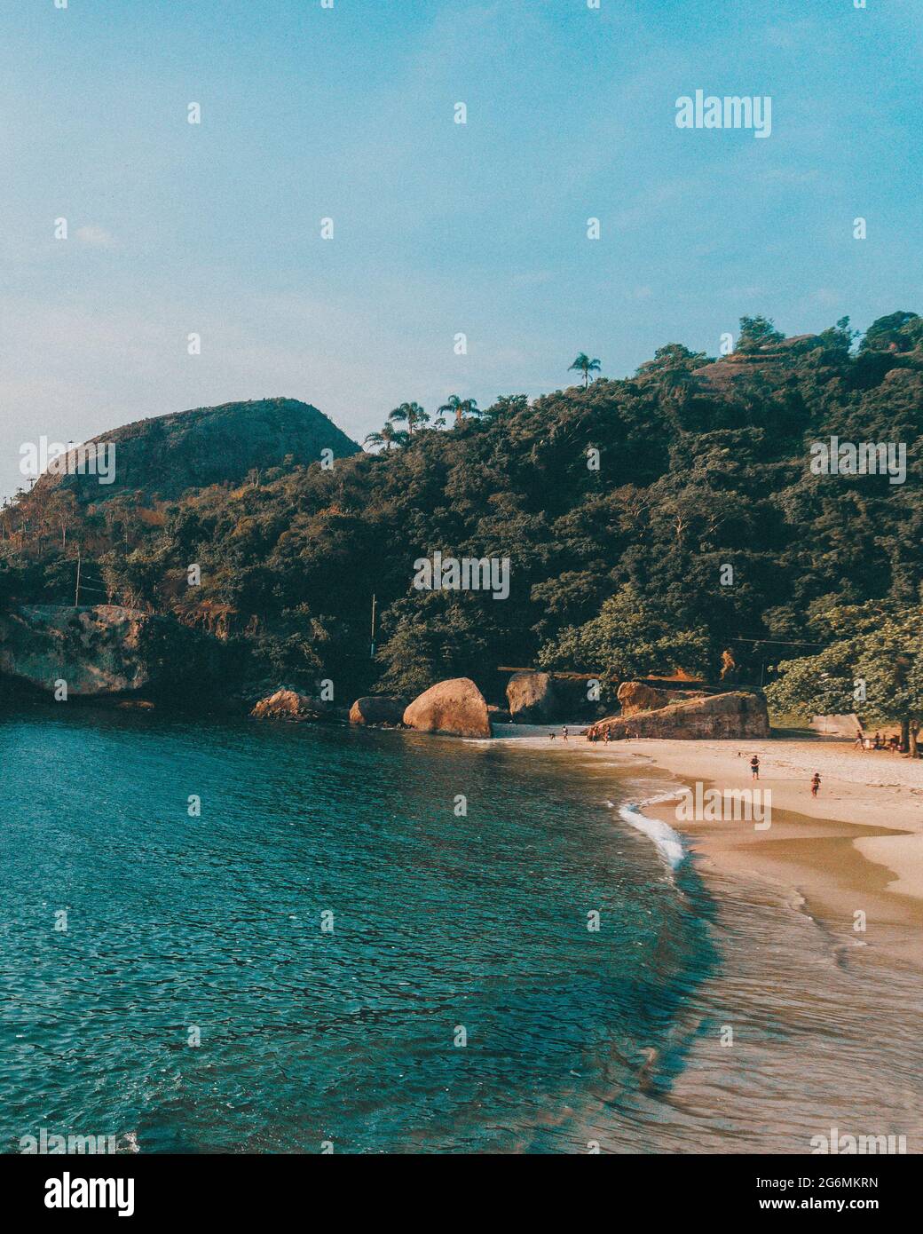 Beautiful azure sea watering the sandy beach and cliffs covered in ...