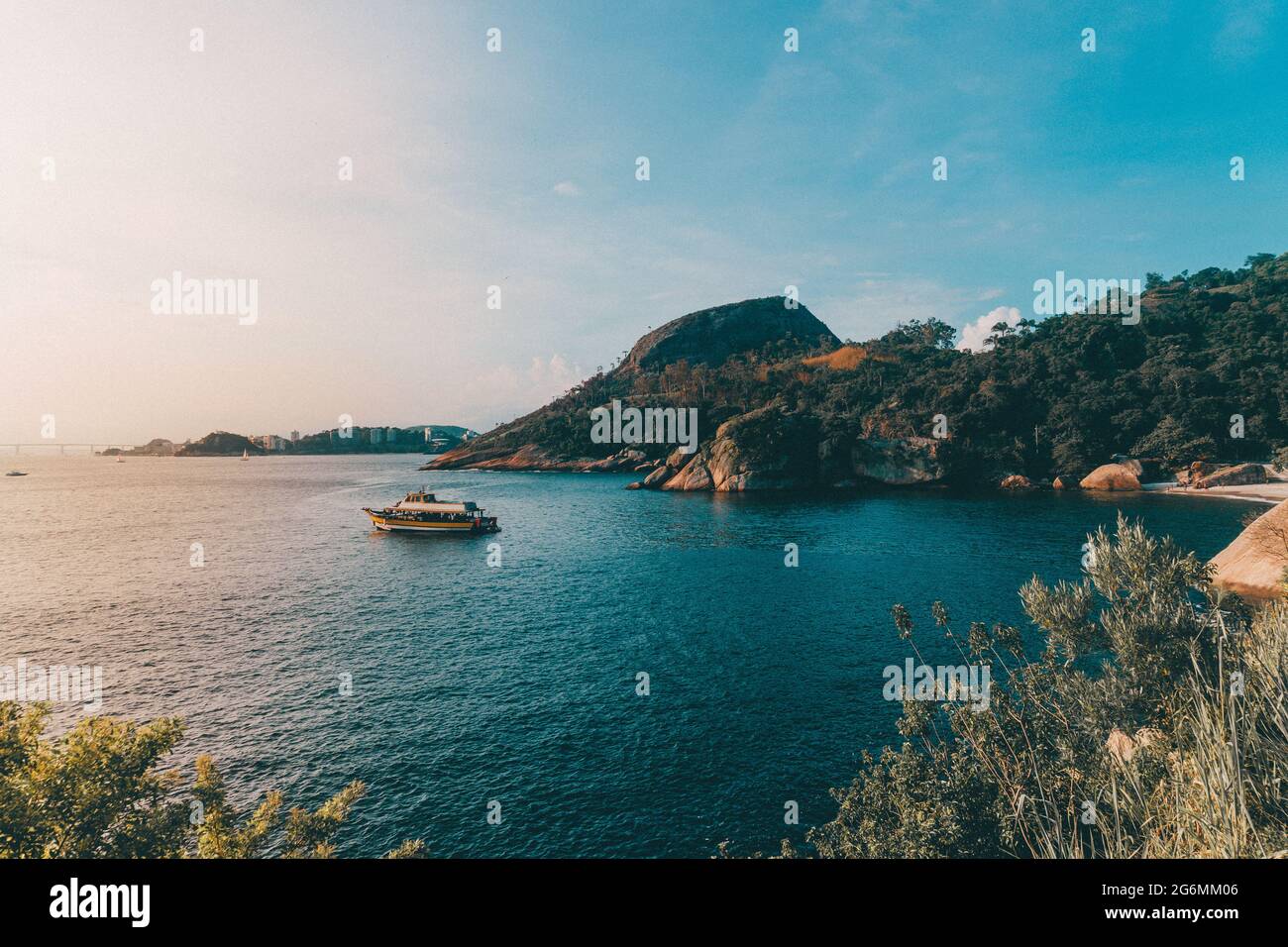 Ship in the azure sea near dense forests of the mountains Stock Photo ...