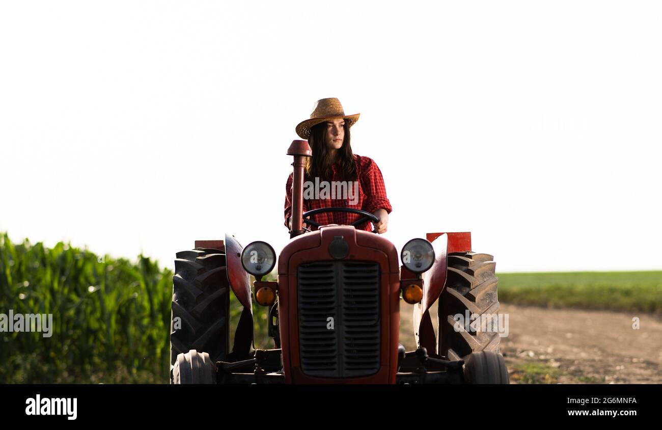 Woman farmer driving old tractor hi-res stock photography and images ...