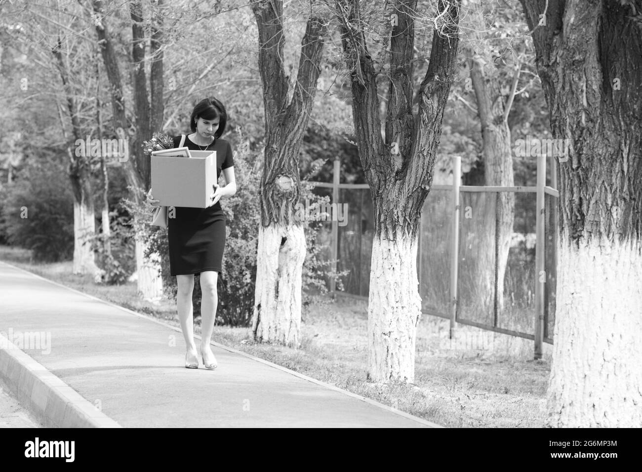 Upset brunette manager after being fired with a box of personal ...