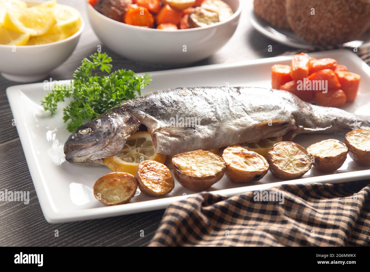 A Whole Baked Rainbow Trout on a Table Set for Dinner Stock Photo - Alamy