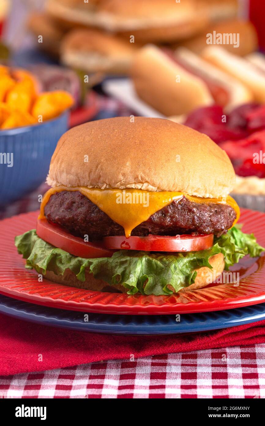 Grilled Cheeseburger on a Table Set for an American BBQ with Red White ...