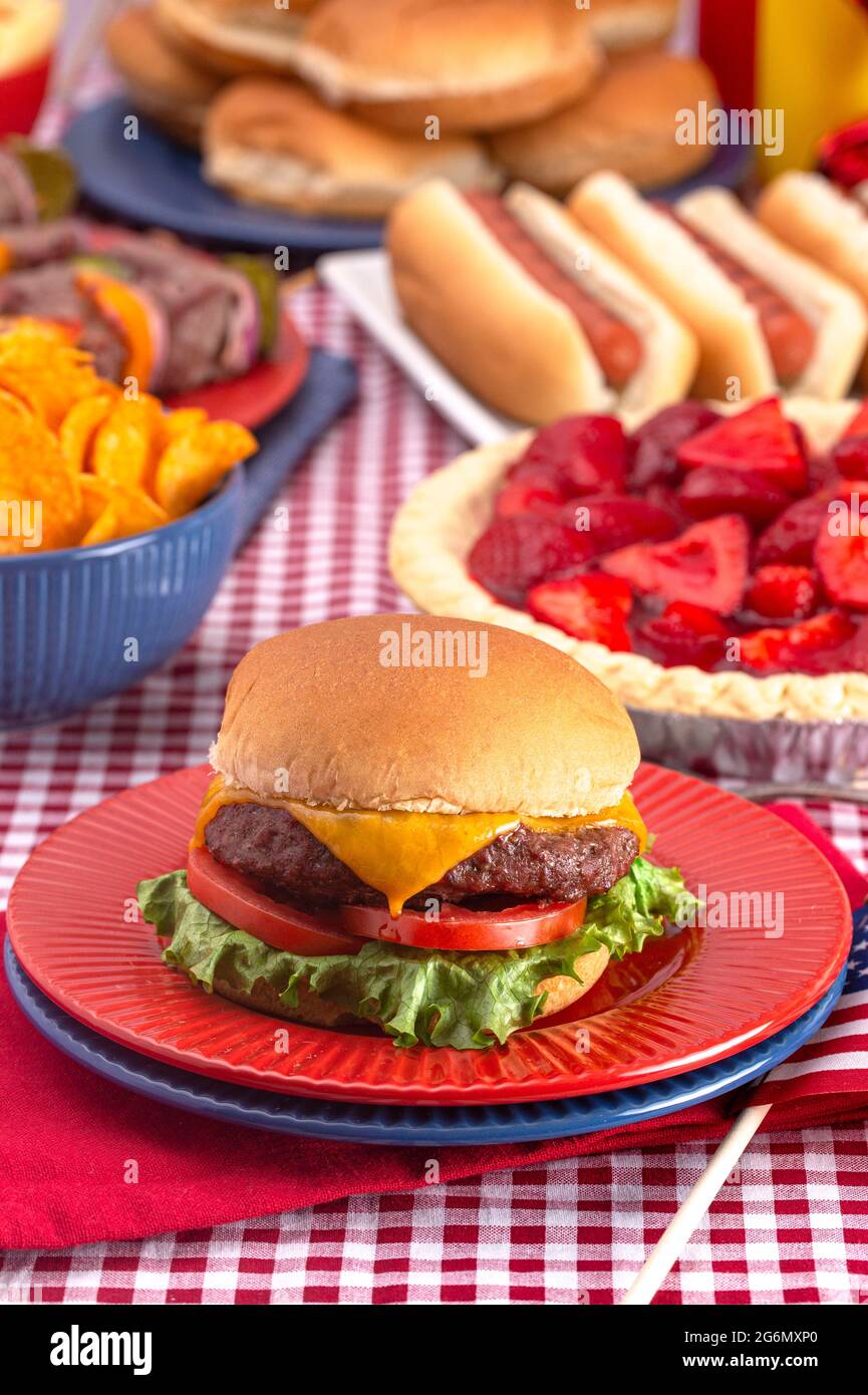 Grilled Cheeseburger on a Table Set for an American BBQ with Red White ...