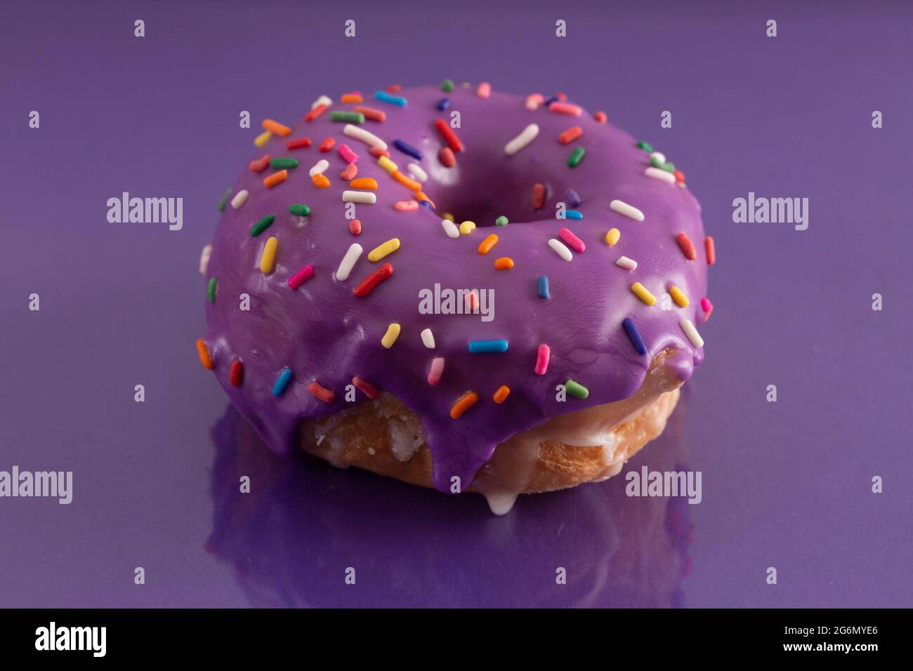 A Purple Glazed Donut with Rainbow Sprinkles on Top Stock Photo - Alamy