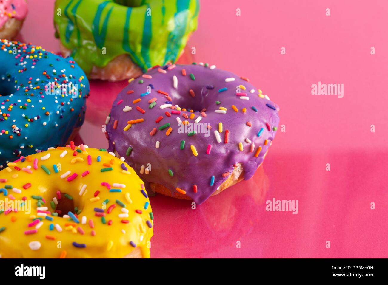 A Batch of Rainbow Colored Glazed Donuts Stock Photo - Alamy