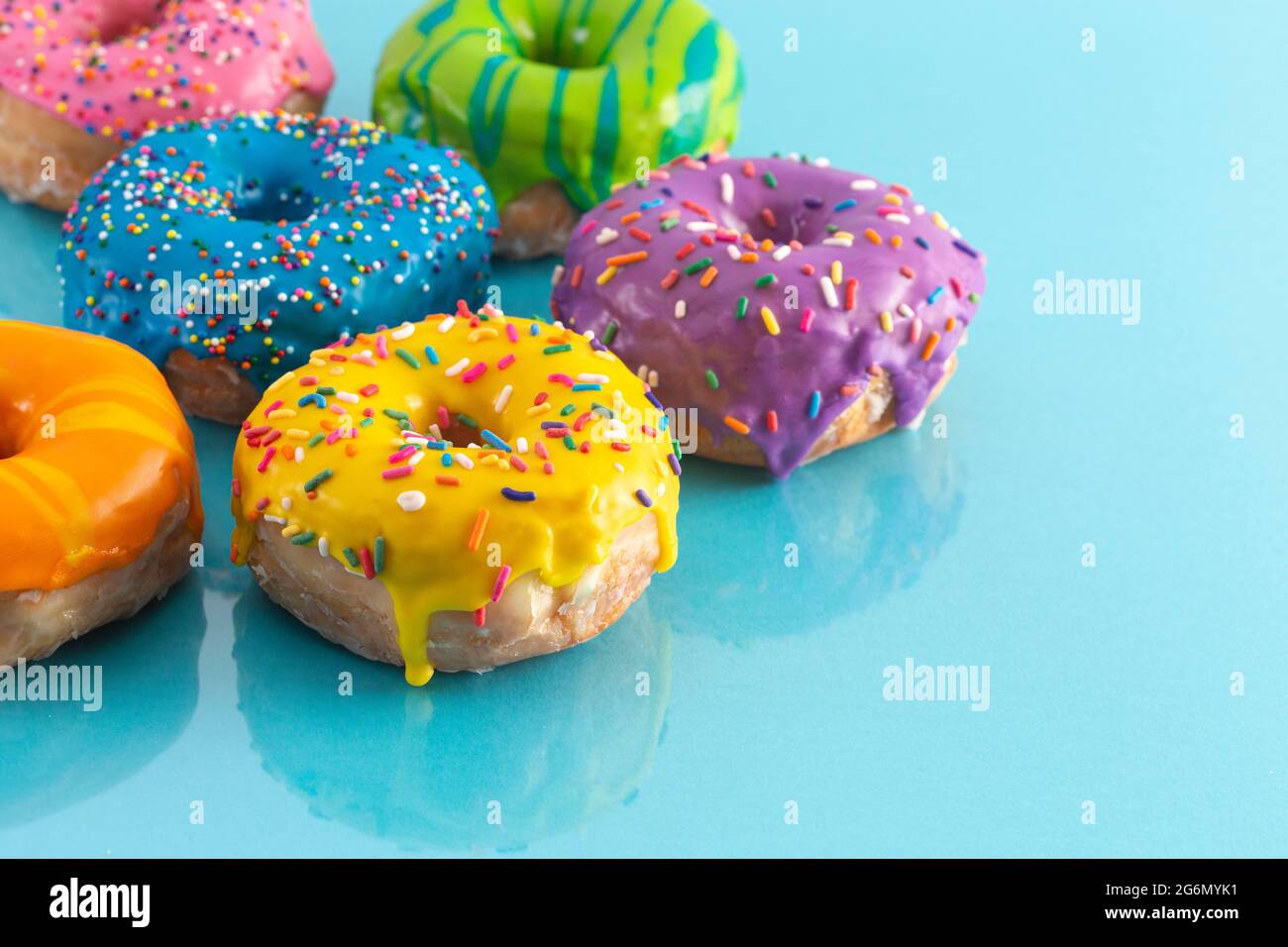 A Batch of Rainbow Colored Glazed Donuts Stock Photo - Alamy