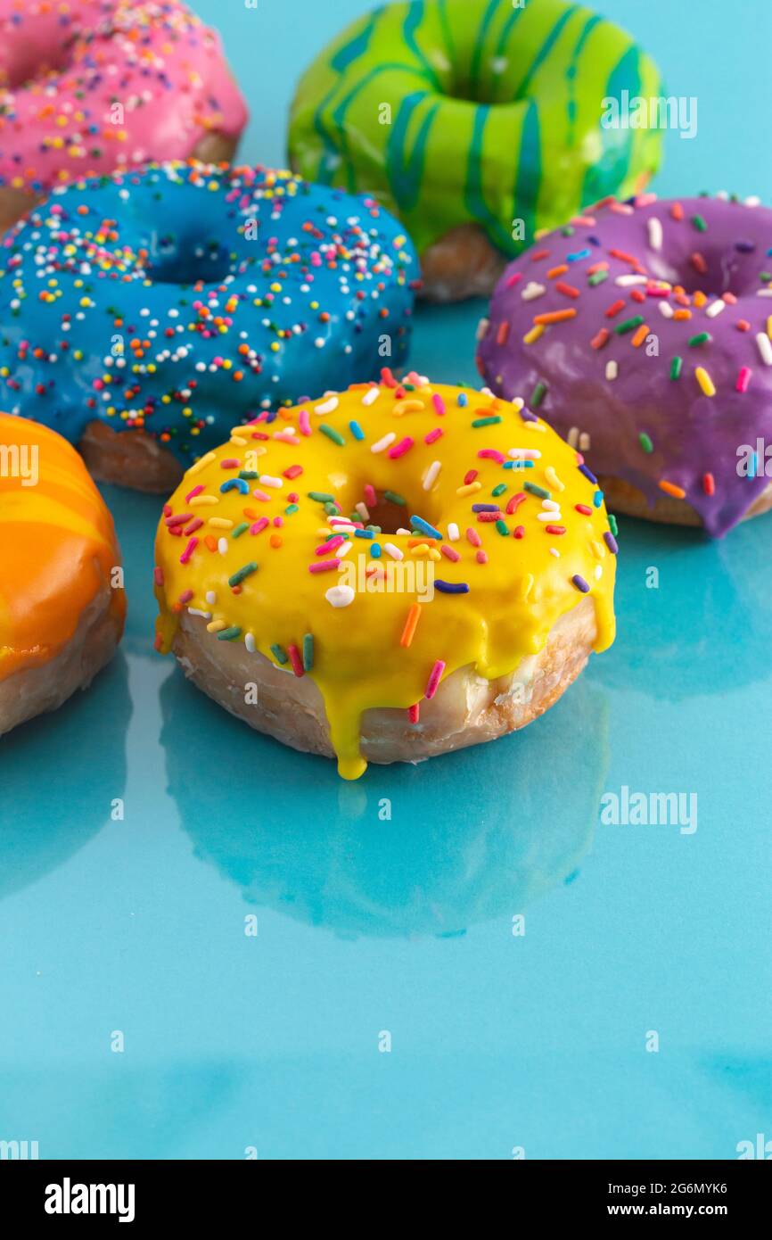 A Batch of Rainbow Colored Glazed Donuts Stock Photo - Alamy