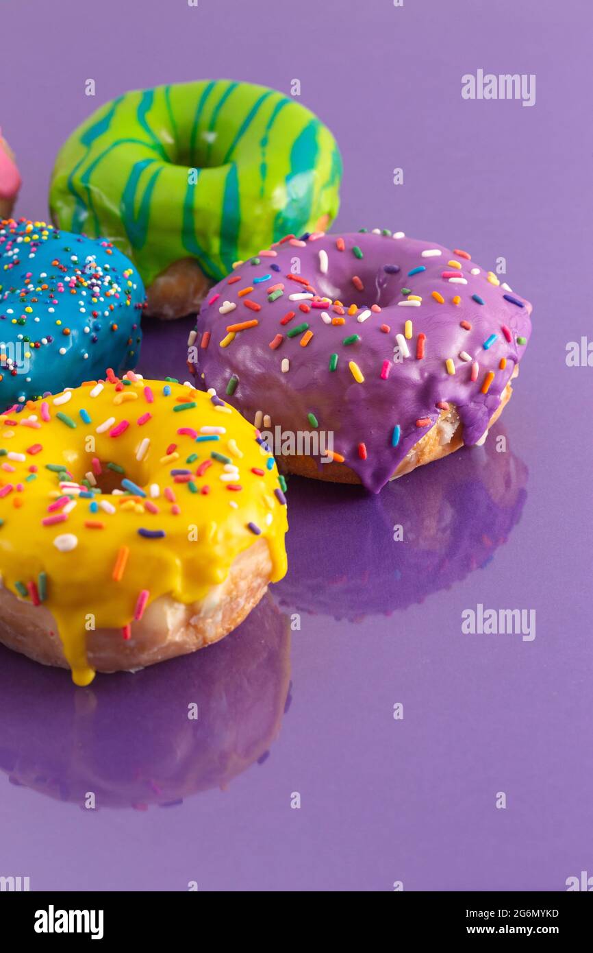 A Batch of Rainbow Colored Glazed Donuts Stock Photo - Alamy