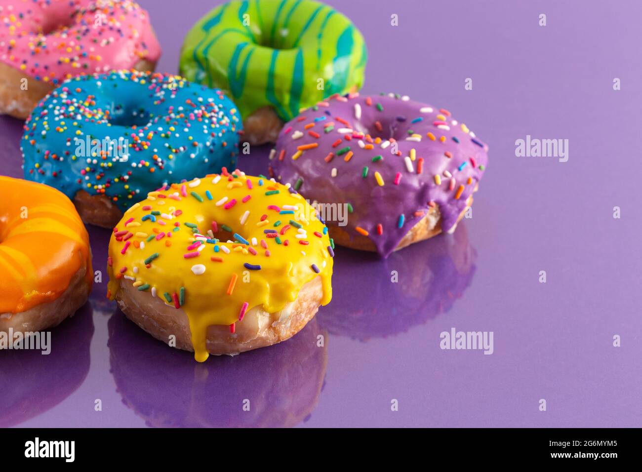A Batch of Rainbow Colored Glazed Donuts Stock Photo - Alamy