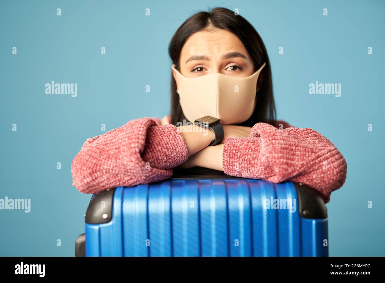 Happy pretty woman going to travel with blue suitcase Stock Photo - Alamy