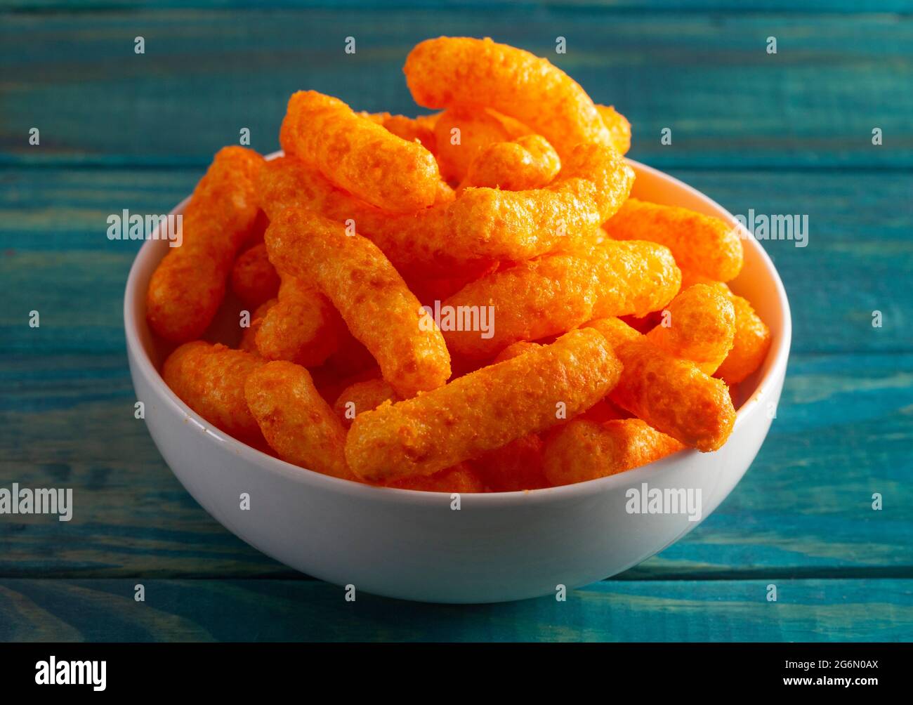 Orange Cheddar Cheese Puffs on a Blue Wood Table Stock Photo - Alamy