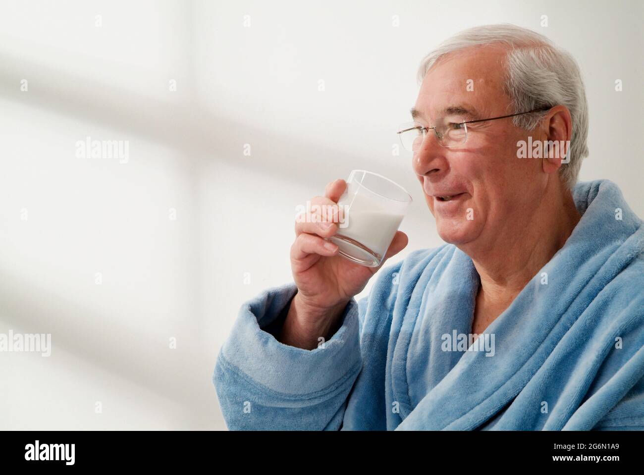 a mature male patient drinking barium sulphate and water from a glass ...