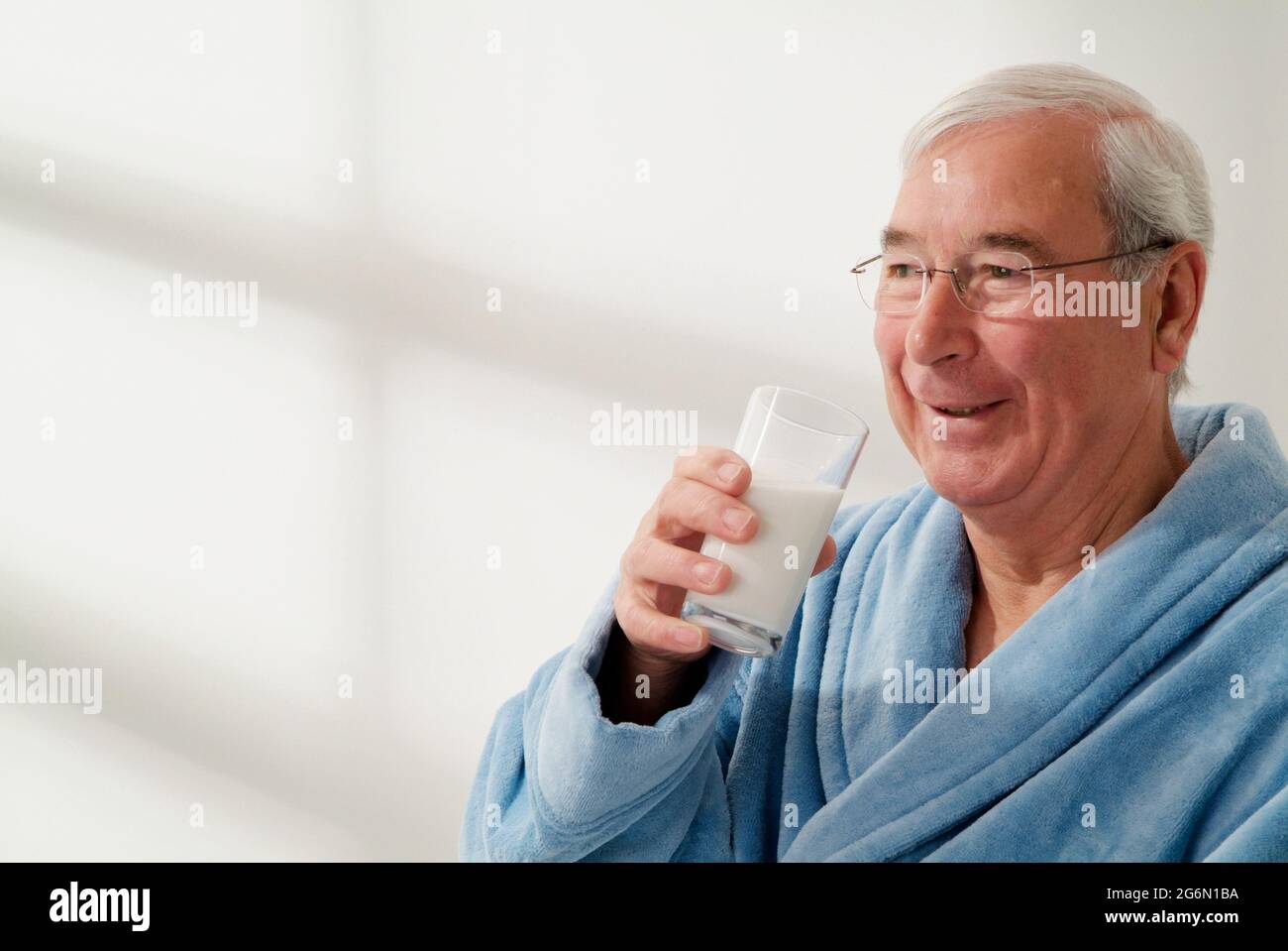 a mature male patient drinking barium sulphate and water from a glass ...