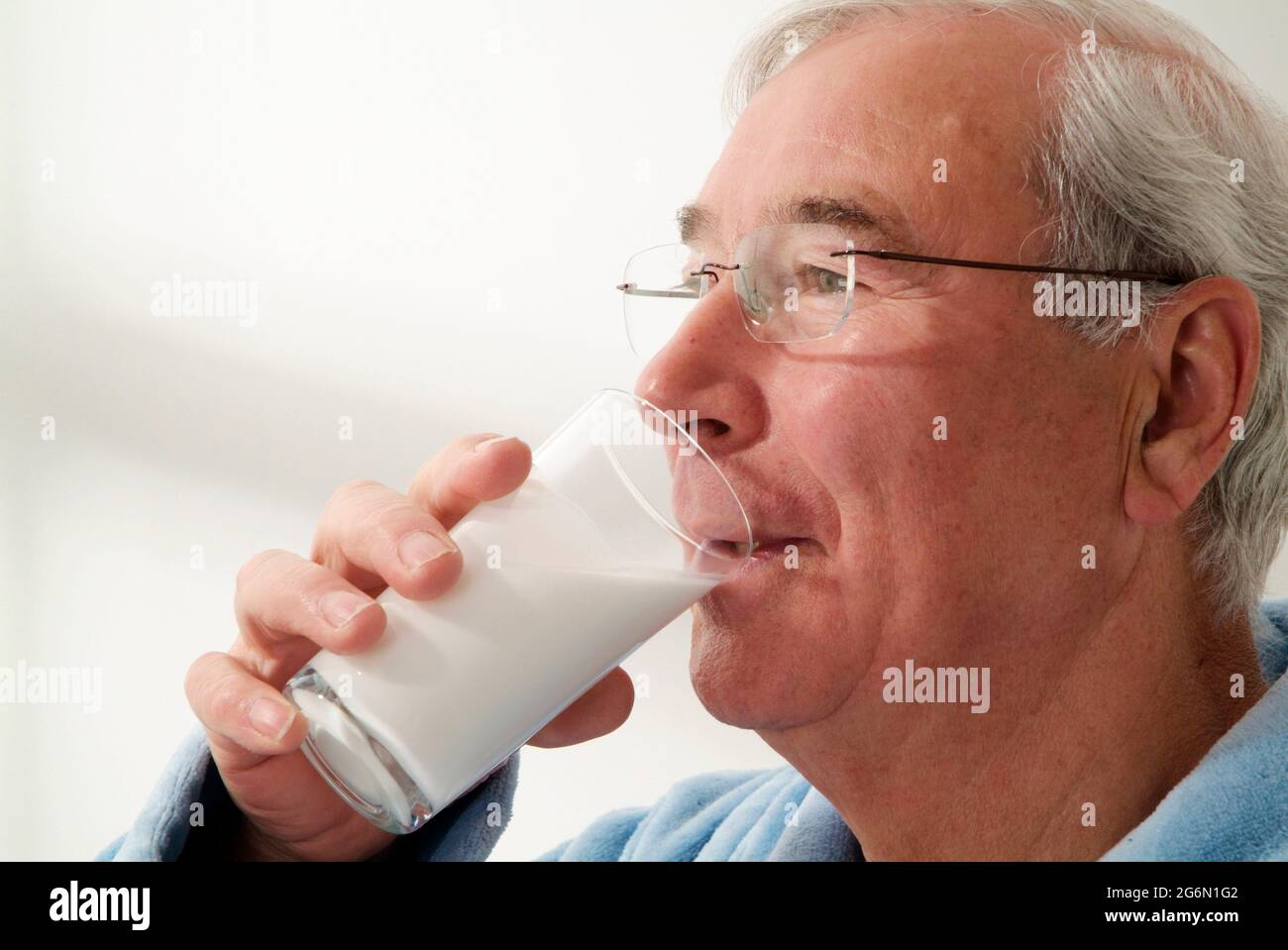 a mature male patient drinking barium sulphate and water from a glass ...