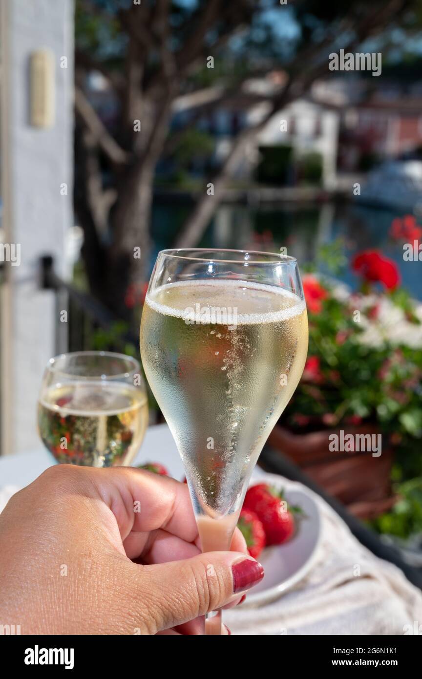 Summer party, pouring of French brut champagne sparkling wine in ...