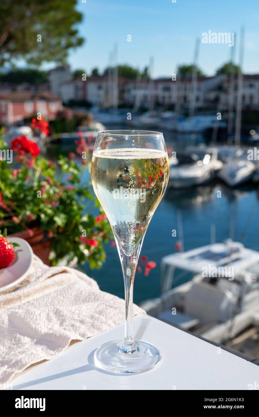 Summer party, pouring of French brut champagne sparkling wine in ...