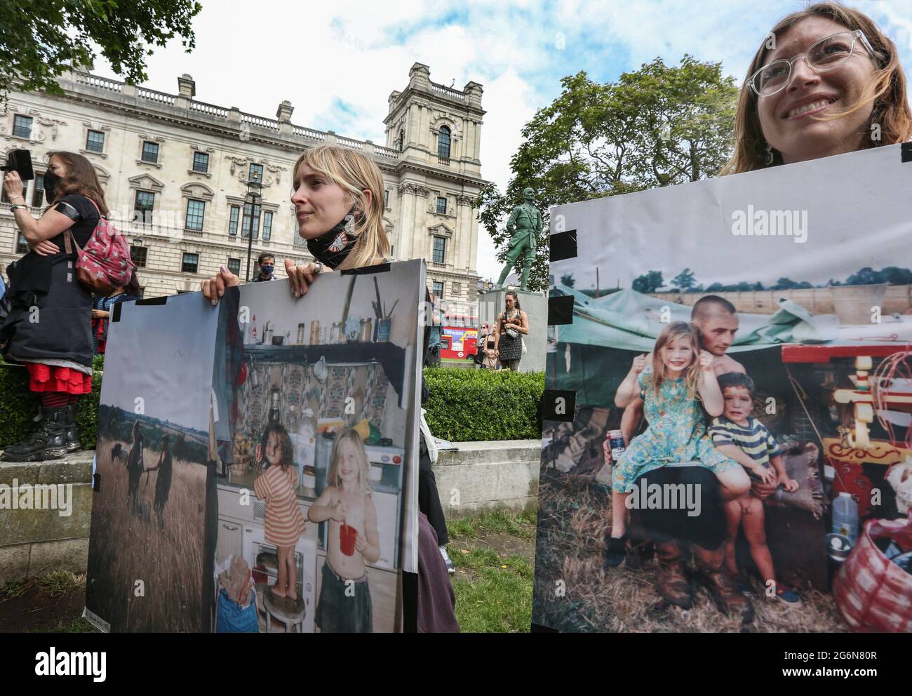 Protesters hold pictures from the travelling community during the ...